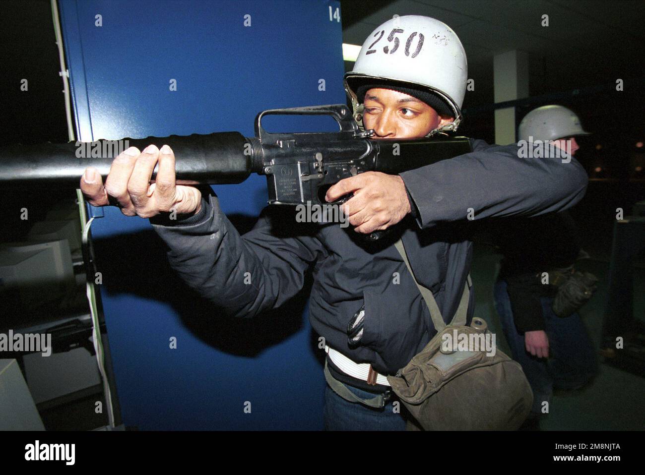 SEAMAN Recruit Martin D. Lawrence, fires the M-16 simulator during the ...