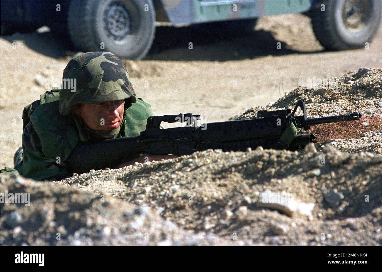 A Marine from the Wing Support Squadron 371 (MWSS-371) lays prone next ...