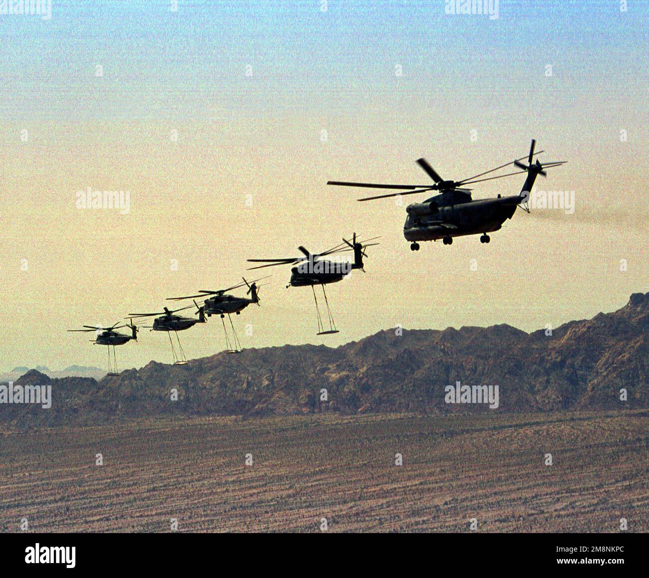 Four of five Marine CH-53E Sea Stallion helicopters fly in-line ...