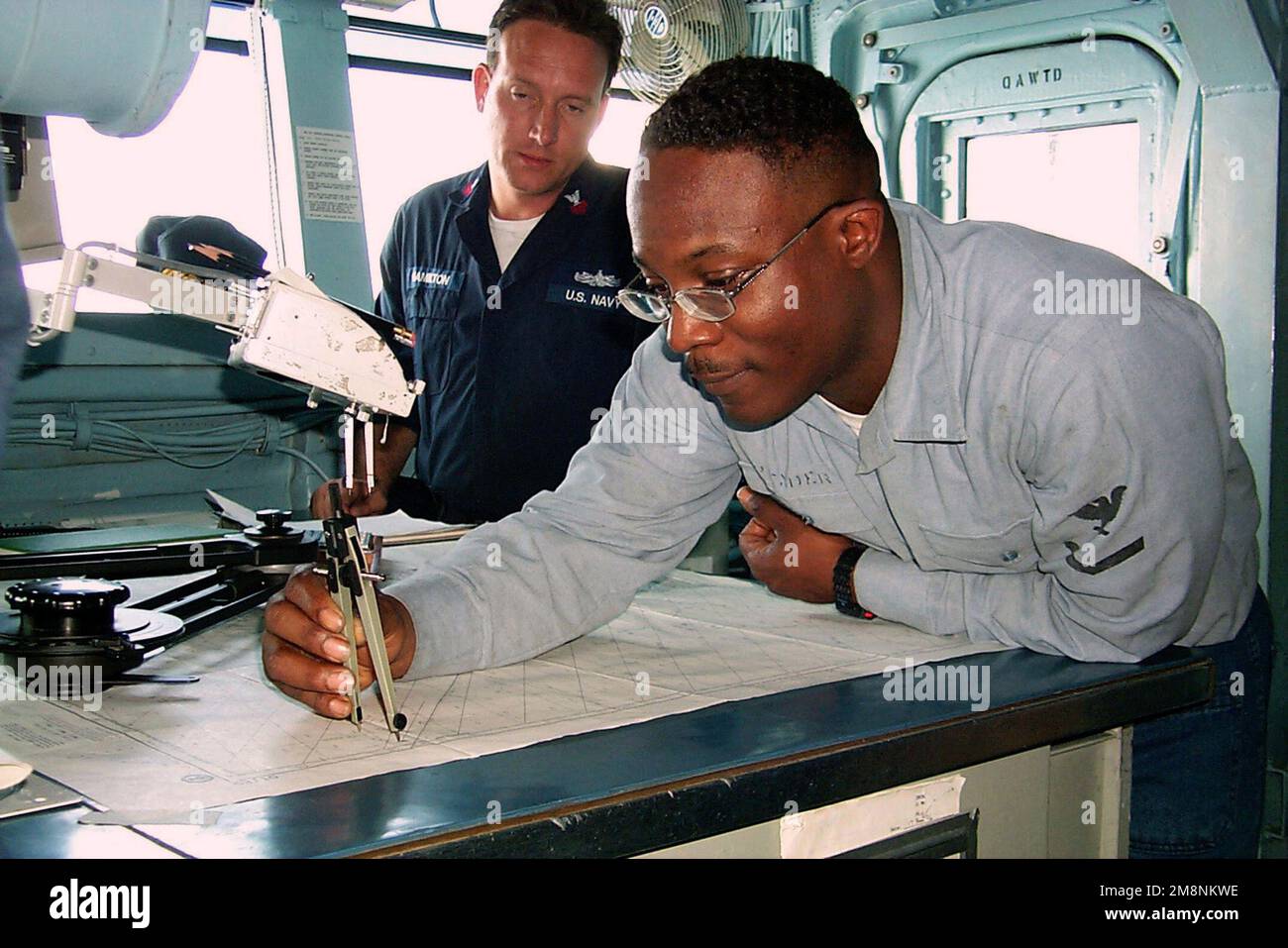 Signalman 1ST Class Vincent E. Hamilton (L) watches on as Quartermaster ...