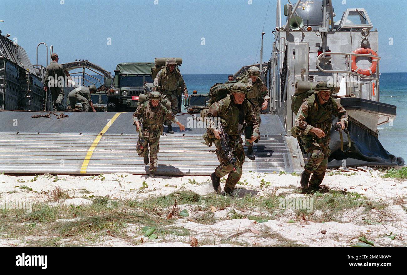 US Marines disembark from a Landing Craft Air Cushion (LCAC) during an ...