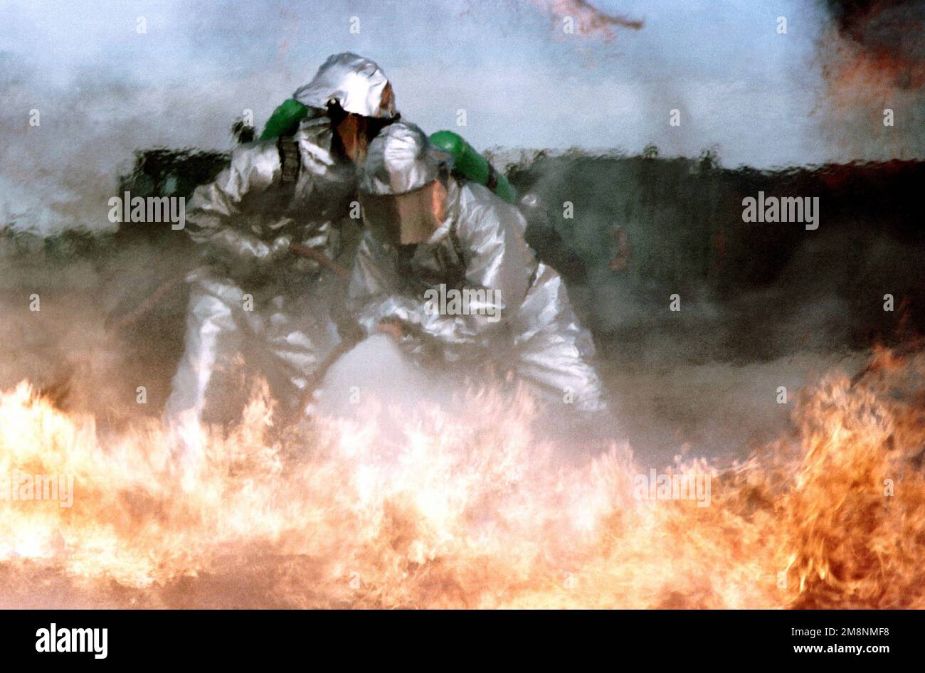 Two crash fire rescue Marines fight an extremely hot jet fuel fire to ...