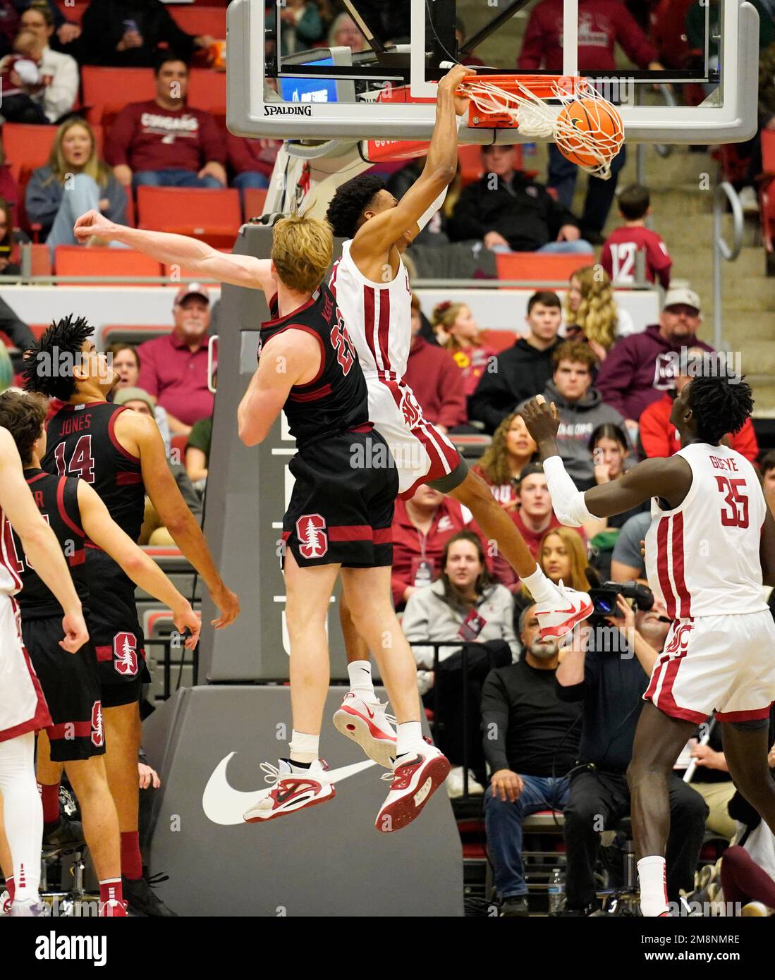 Washington State forward Carlos Rosario, center right, dunks over ...