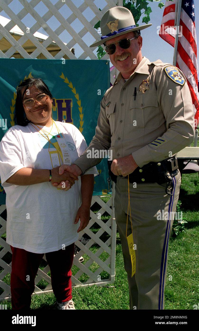 Buellton, California Highway Patrolman Ken Hoyle (Right) congratulates ...
