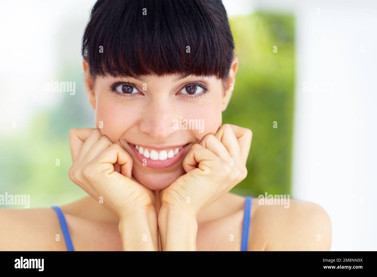 Cute and sweetly smiling. Lovely young woman giving a big smile with ...