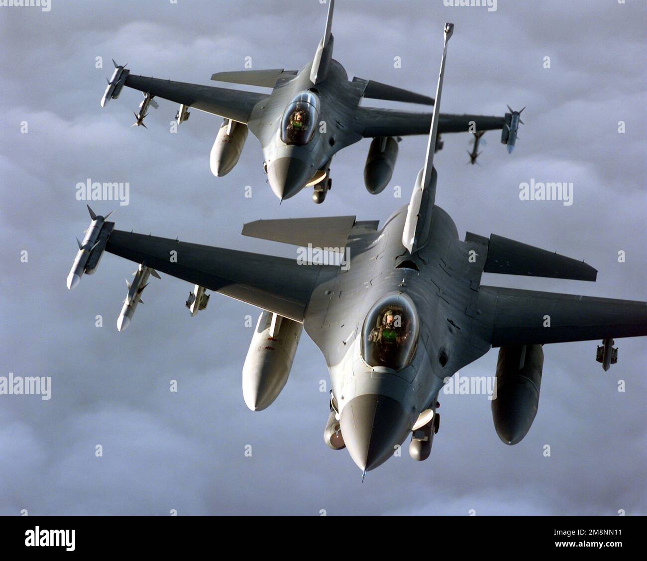 Two United States Air Forces Europe F-16Cs fly in formation during a ...