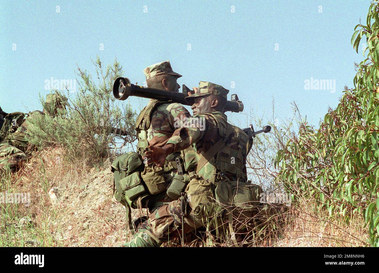 Right side rear view from a low angle, up at two Marines from 1ST ...