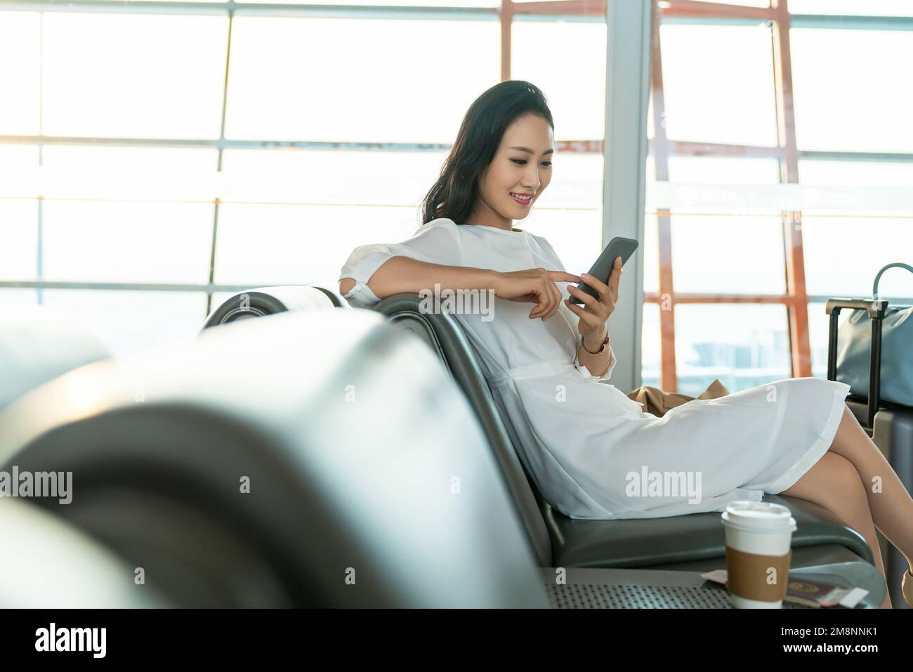 The use of mobile phones business lady in the airport lounge Stock ...