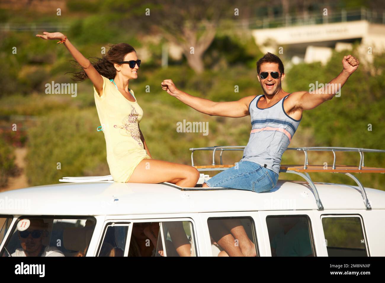 Free to be me. A young man and woman throwing their arms up in the air ...