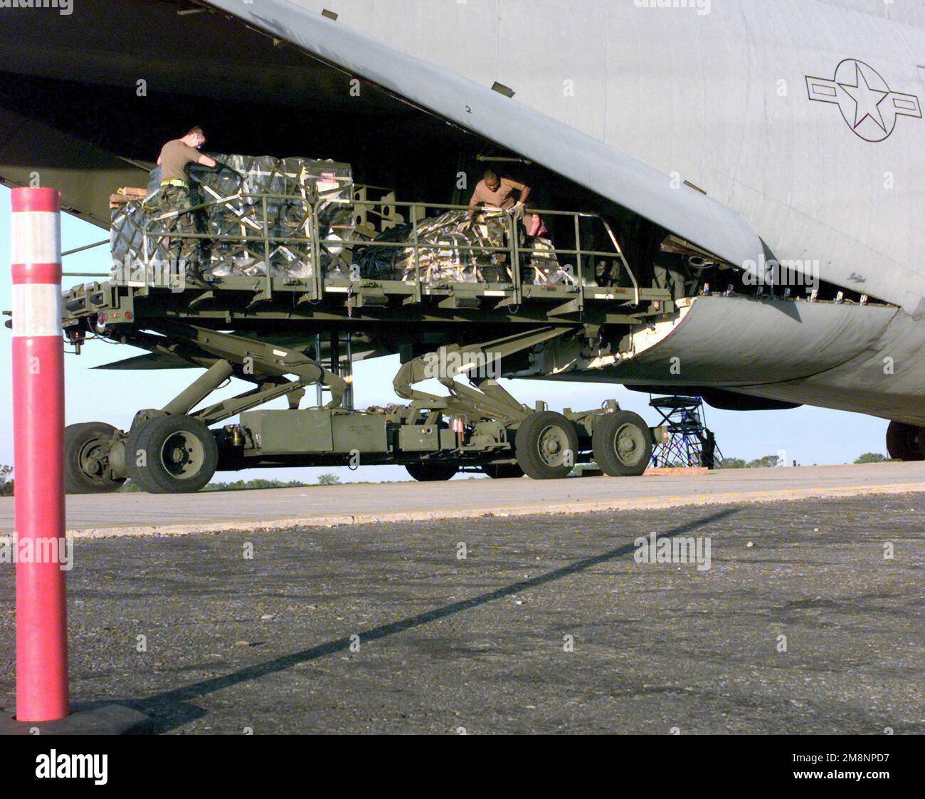 The K-loader raised to meet the aircrafts lowered ramp, cargos ...