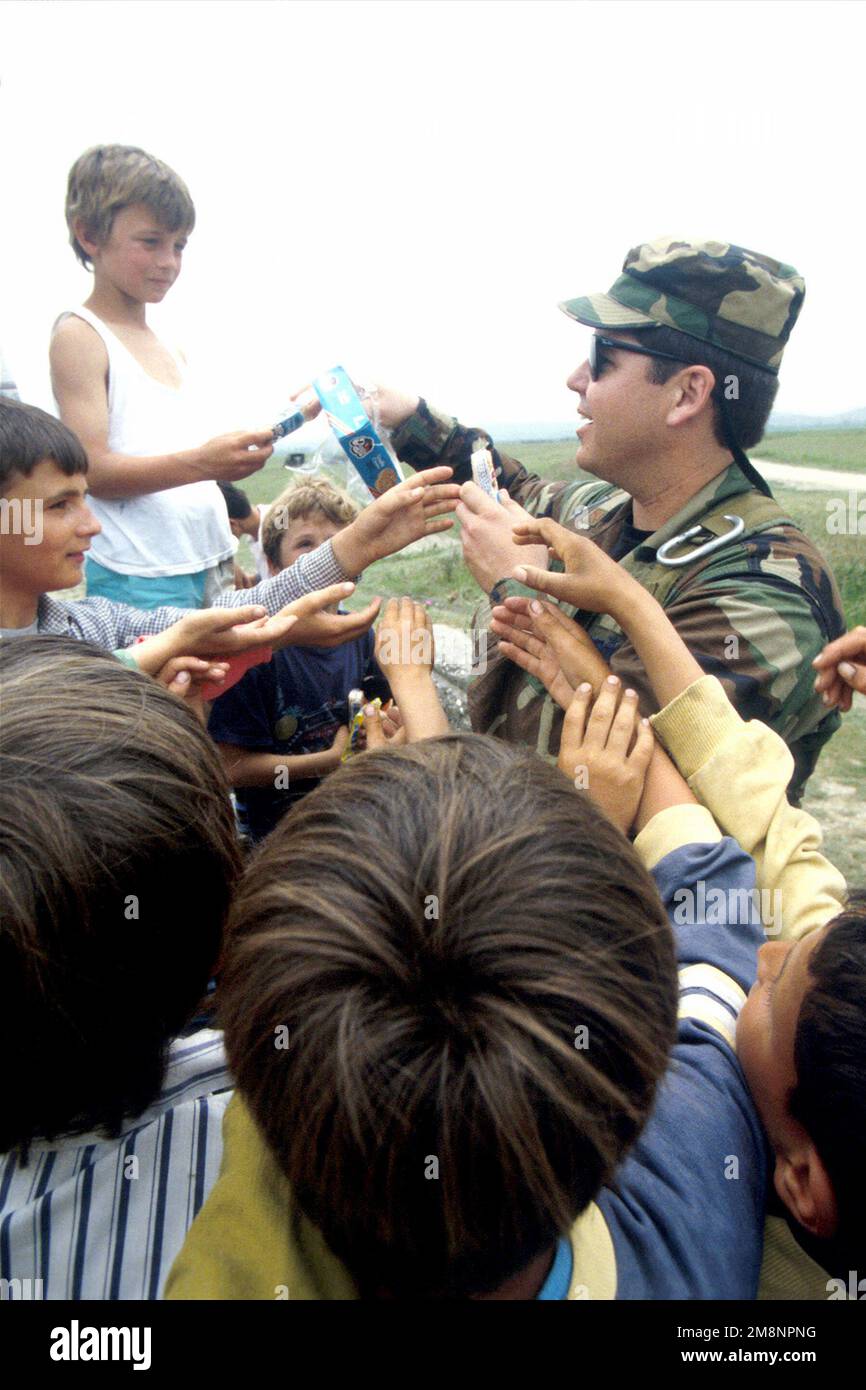 Albanian children accept goodies and toys from Major Mike Hamill, a C-5 ...