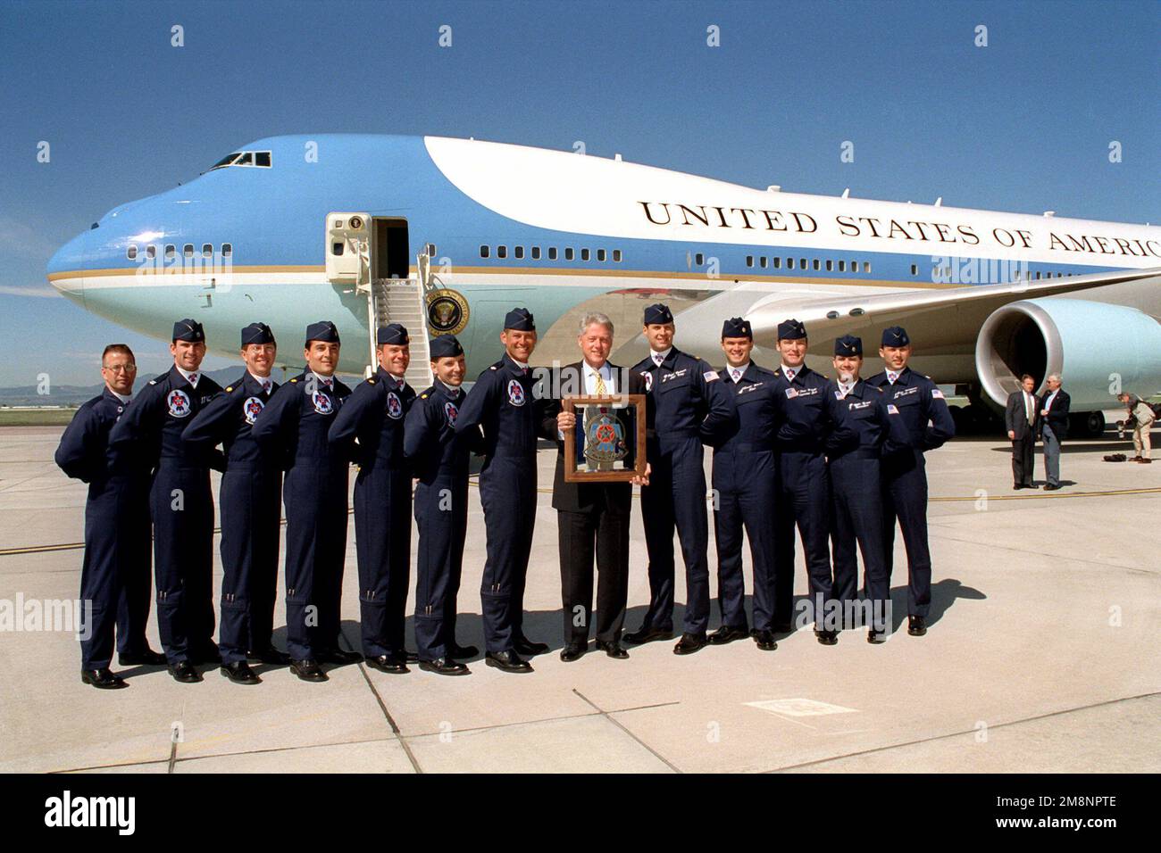 US President William Jefferson Clinton holds a mirrored gift presented ...