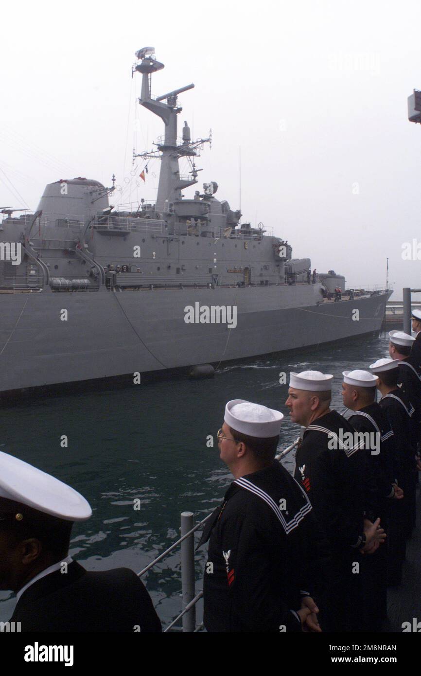 Sailors from USS REUBEN JAMES (FFG 57) man the rails as they pull along ...