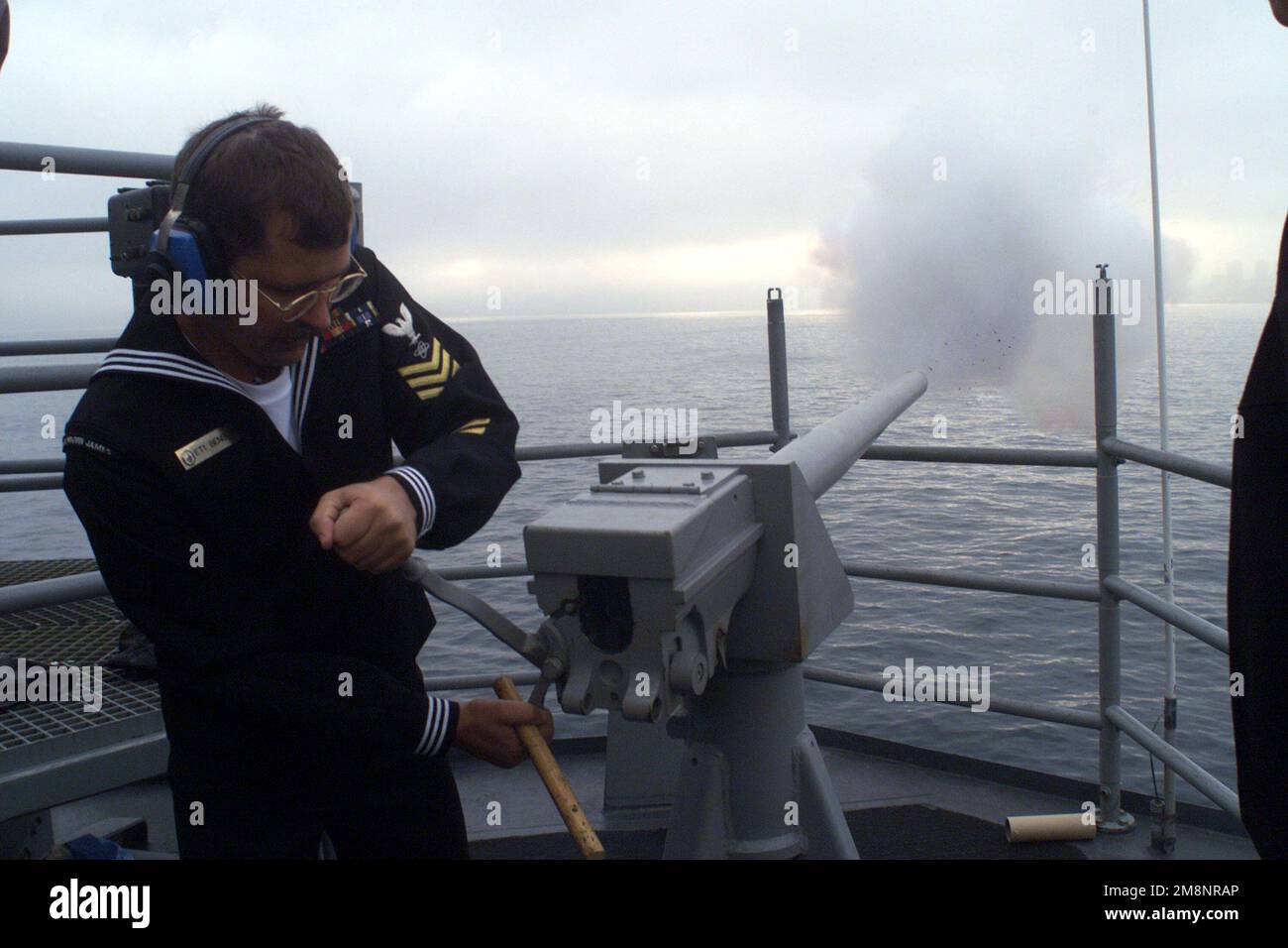 US Navy Electronics Technician First Class Tim Benson fires the ...