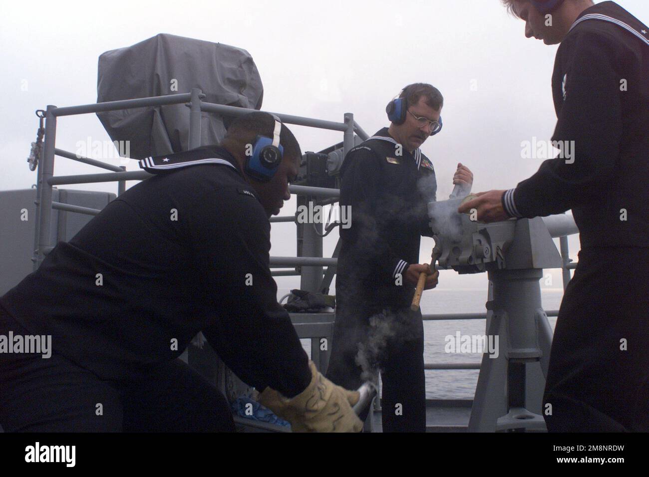 US Navy GUNNER's Mate First Class Rupert Rose catches the spent ...