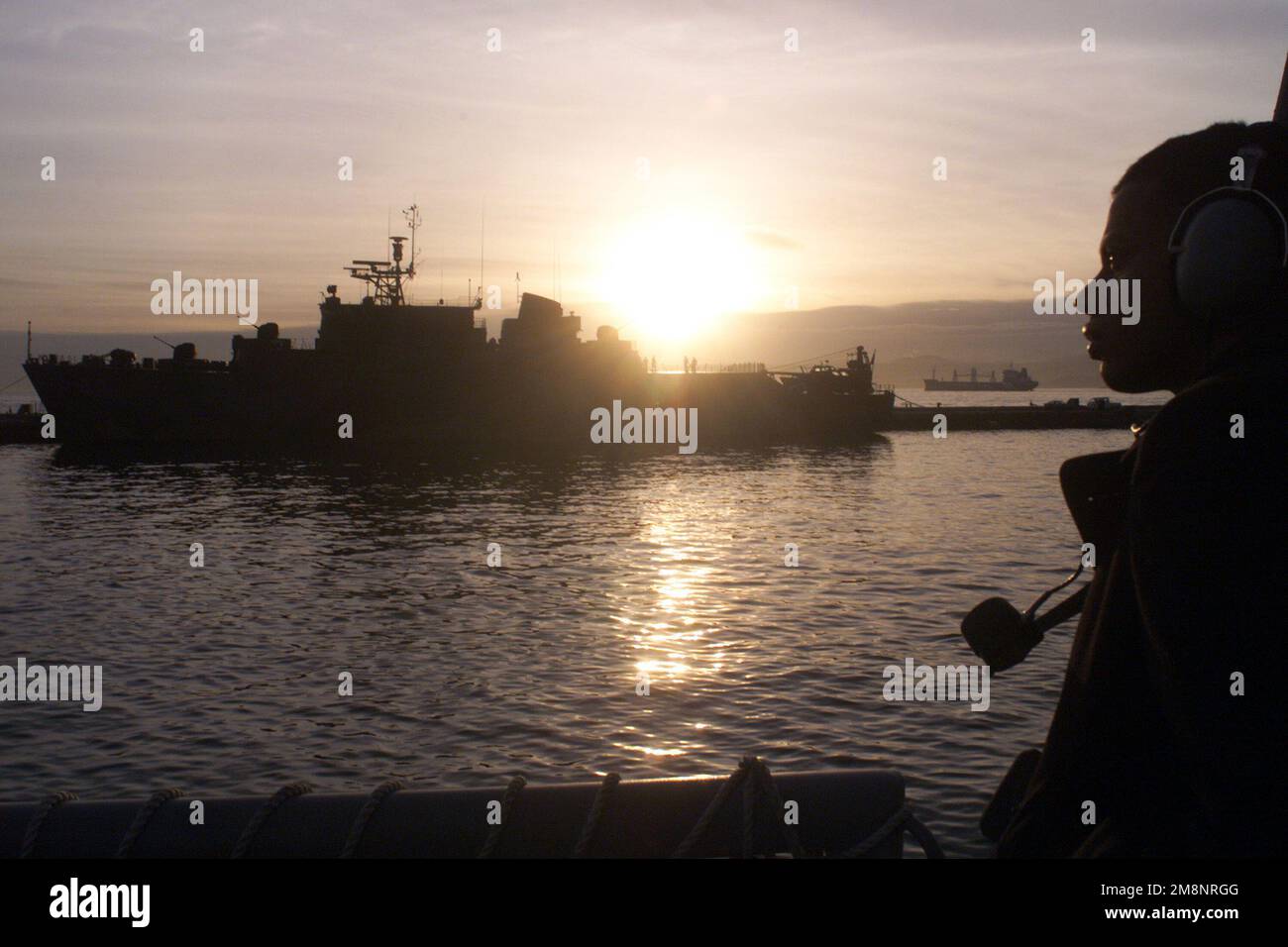 The early sun rises behind a Chilean naval vessel while US Navy Fire ...