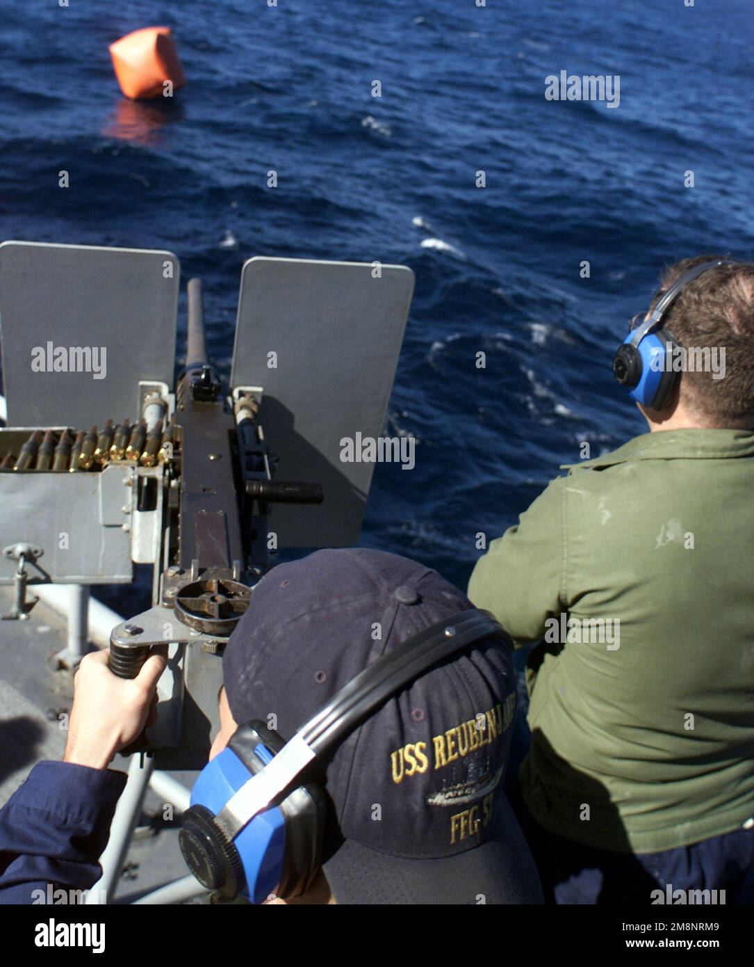 A crewman aboard USS REUBEN JAMES (FFG 57) prepares to fire his .50 ...