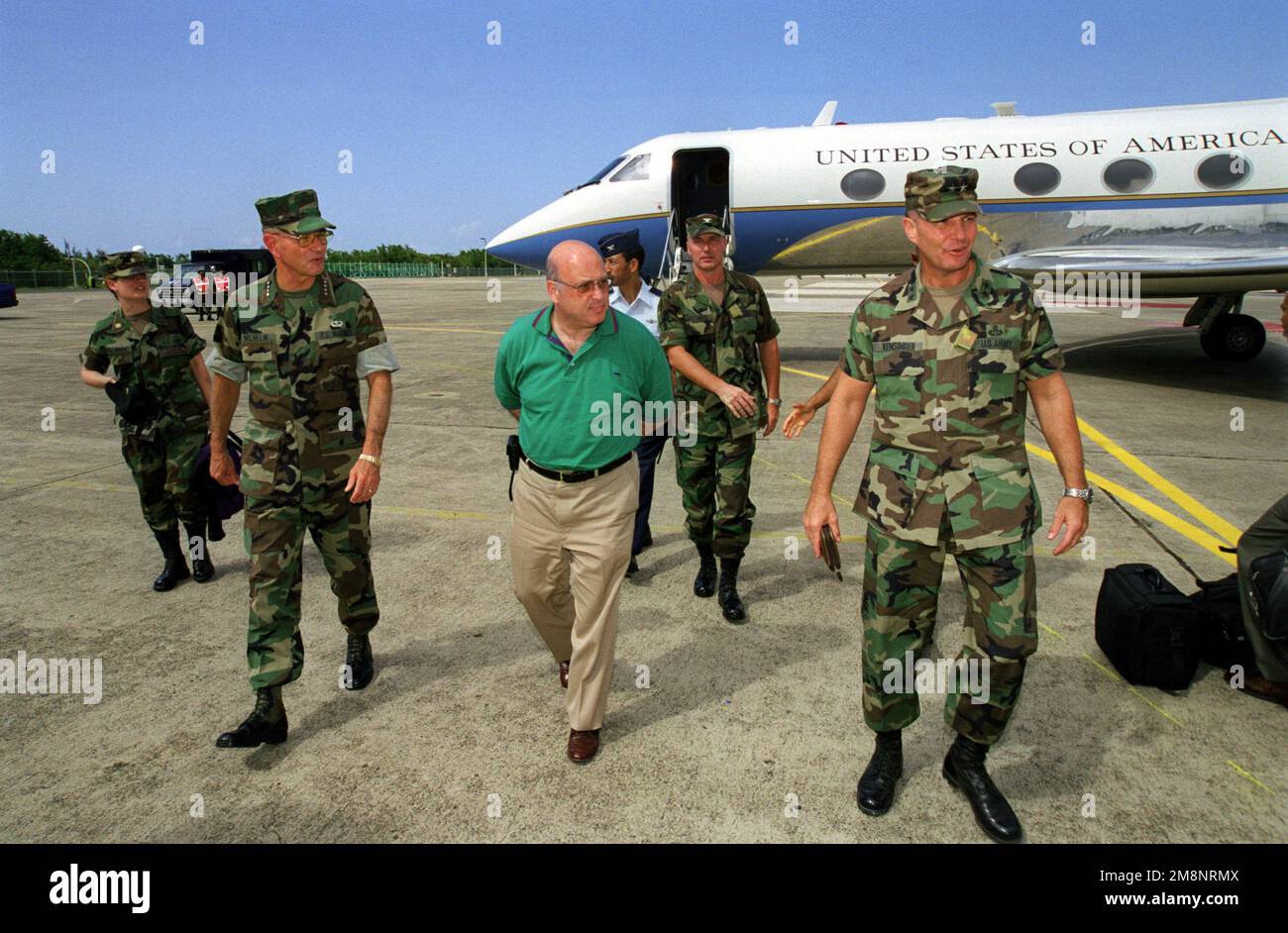 Dr. Bernard Rostker, Under Secretary of the Army (center), is escorted ...