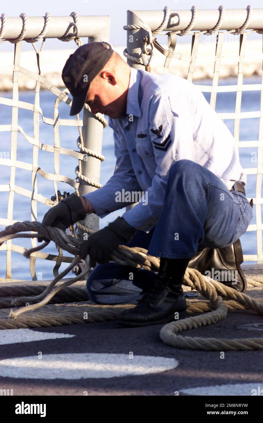 US Navy Boatswain's Mate 2nd Class Mikal Olson, splices new eyes in the ...