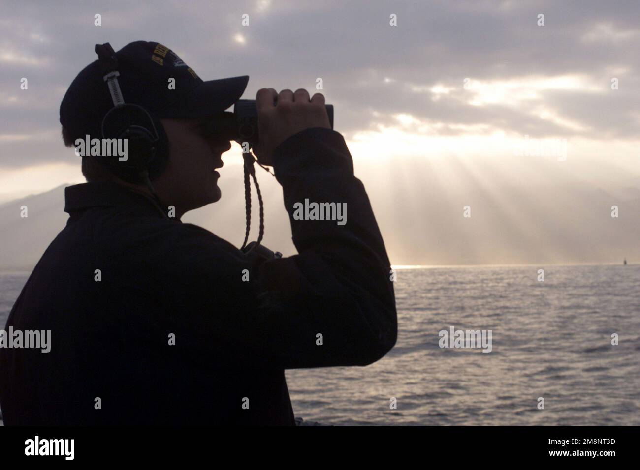 US Navy SEAMAN Sam Devaldo stands the aft look out aboard USS REUBEN ...