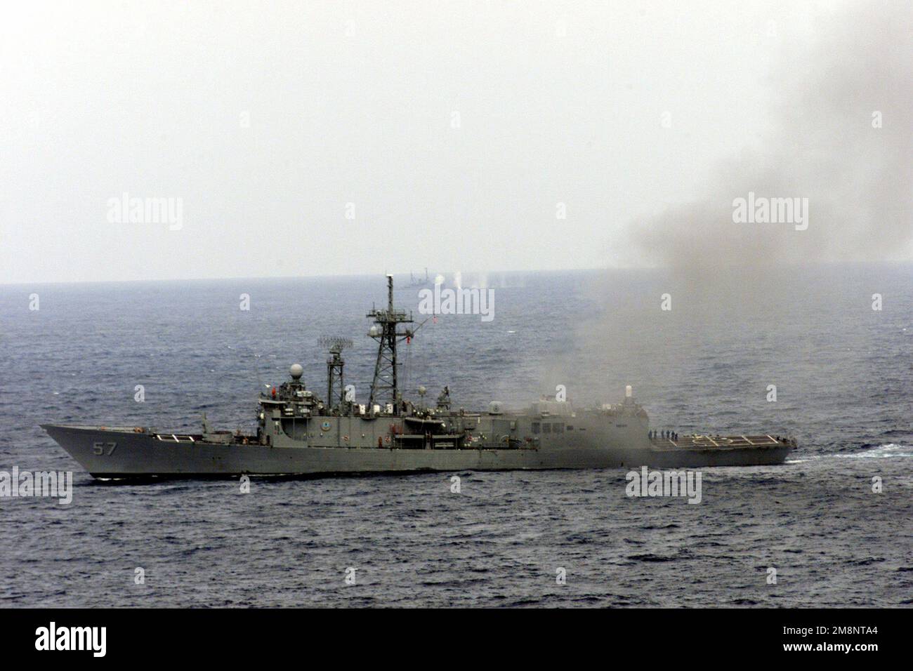 USS REUBEN JAMES (FFG 57) fires its .76mm gun at an ocean tug during a ...