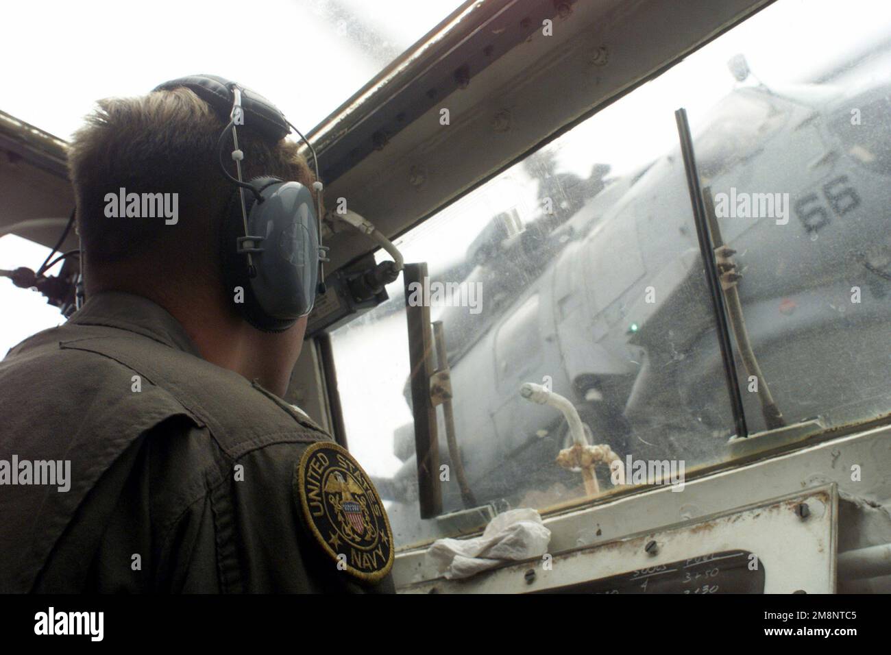 US Navy Lieutenant Junior Grade Phillip Whitmore guides a Helicopter ...