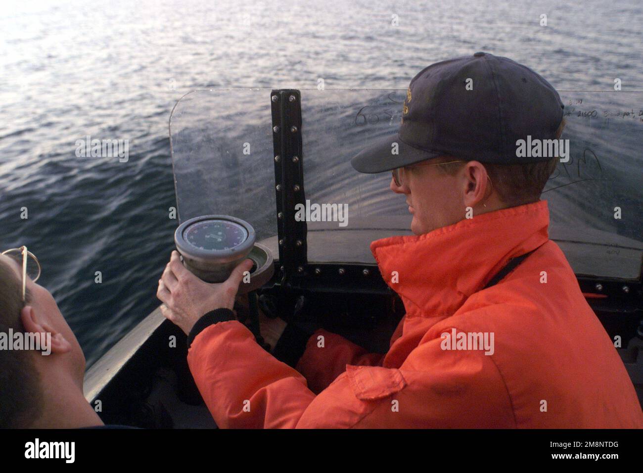 US Navy Lieutenant Commander Rusty Wellham removes the compass on the ...