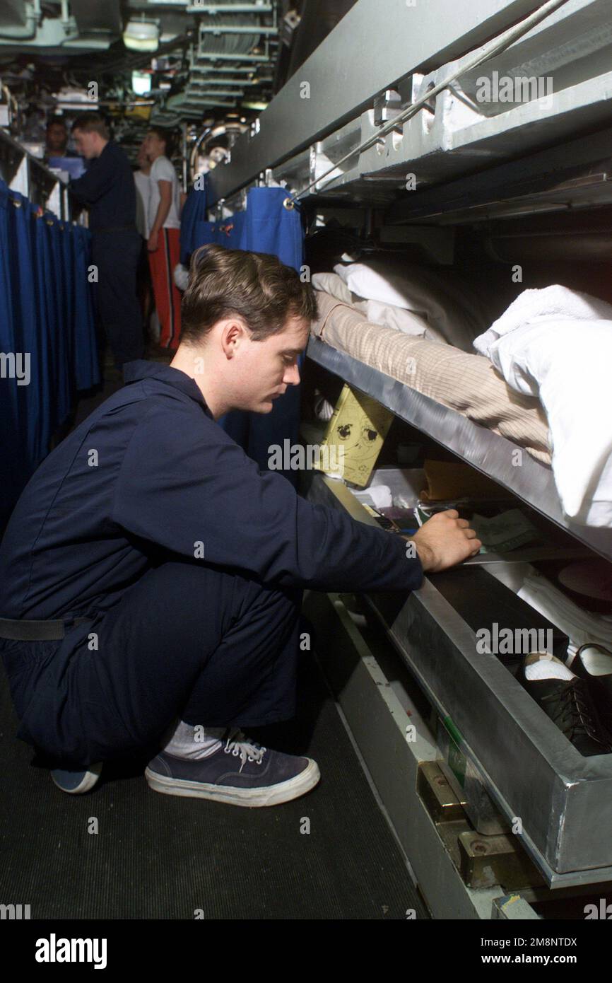 US Navy SEAMAN Ted Fanning opens the coffin locker on his bunk which ...
