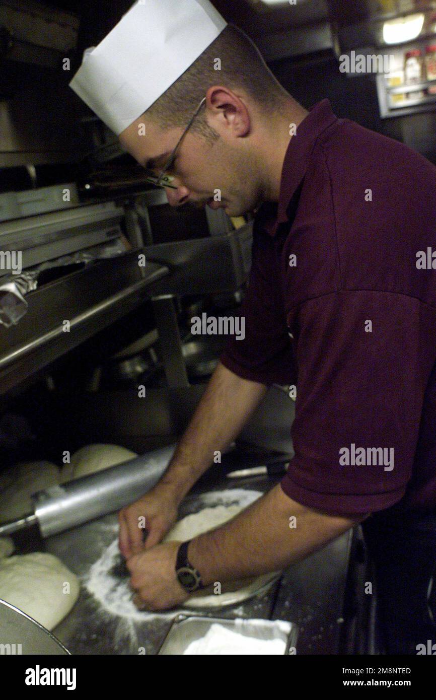 US Navy Mess SPECIALIST 3rd Class Justin Gay rolls pie dough while ...