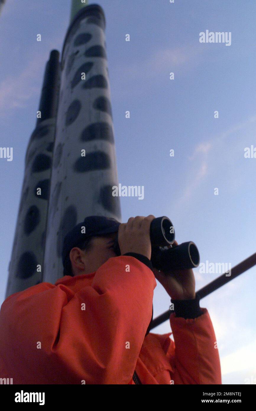 US Navy Store Keeper SEAMAN Jeremy Cash looks across the horizon from ...