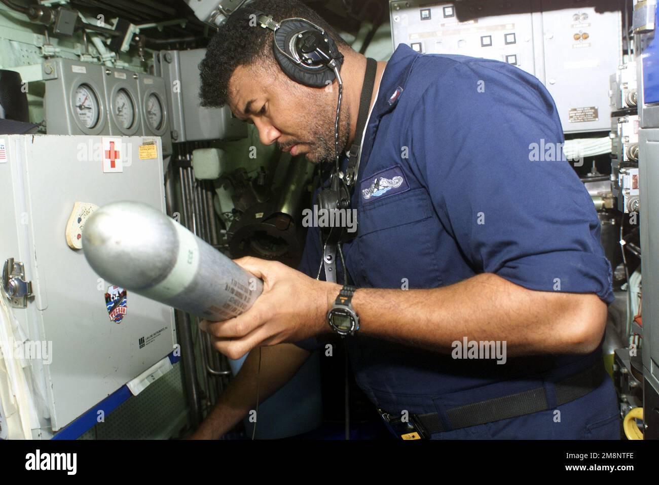 US Navy Torpedoman First Class James Johnson prepares to arm a ...