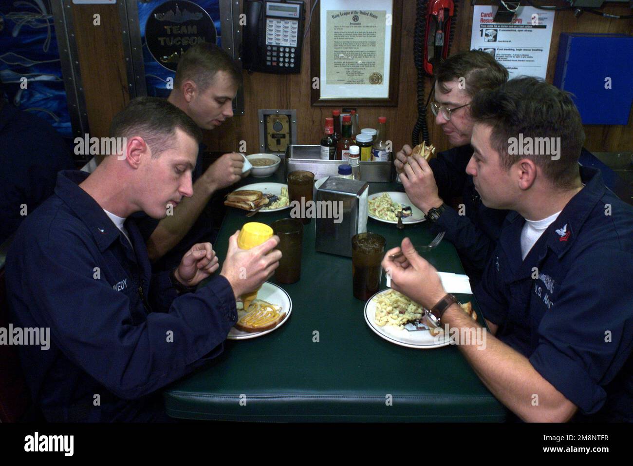 Sailors aboard the fast attack submarine USS TUCSON (SSN 770) break for ...