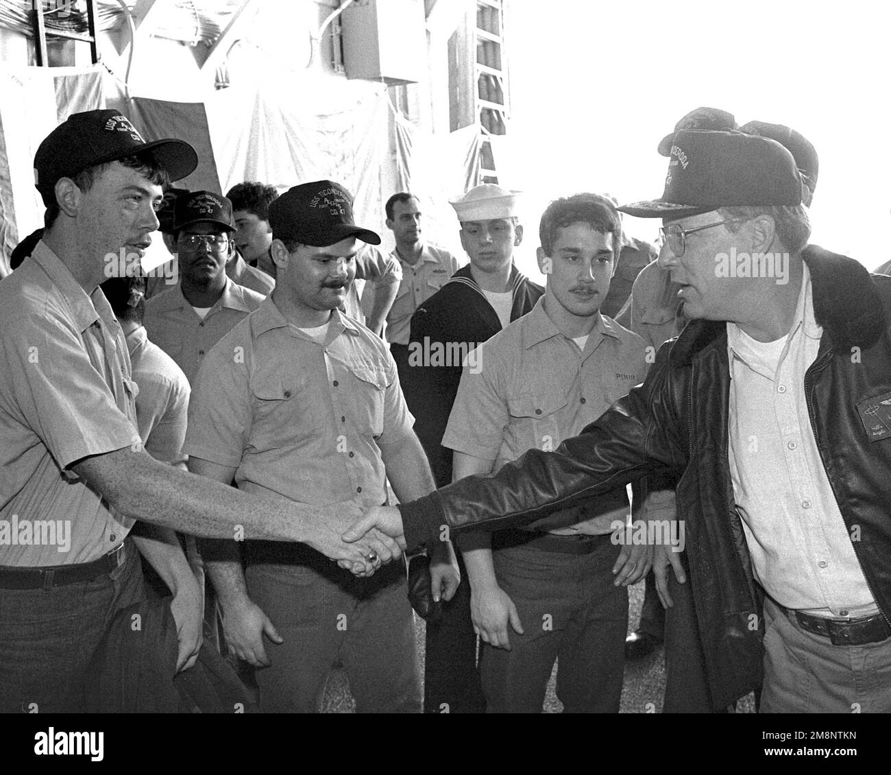 Secretary of the Navy H. Lawrence Garrett III, right, greets members of ...