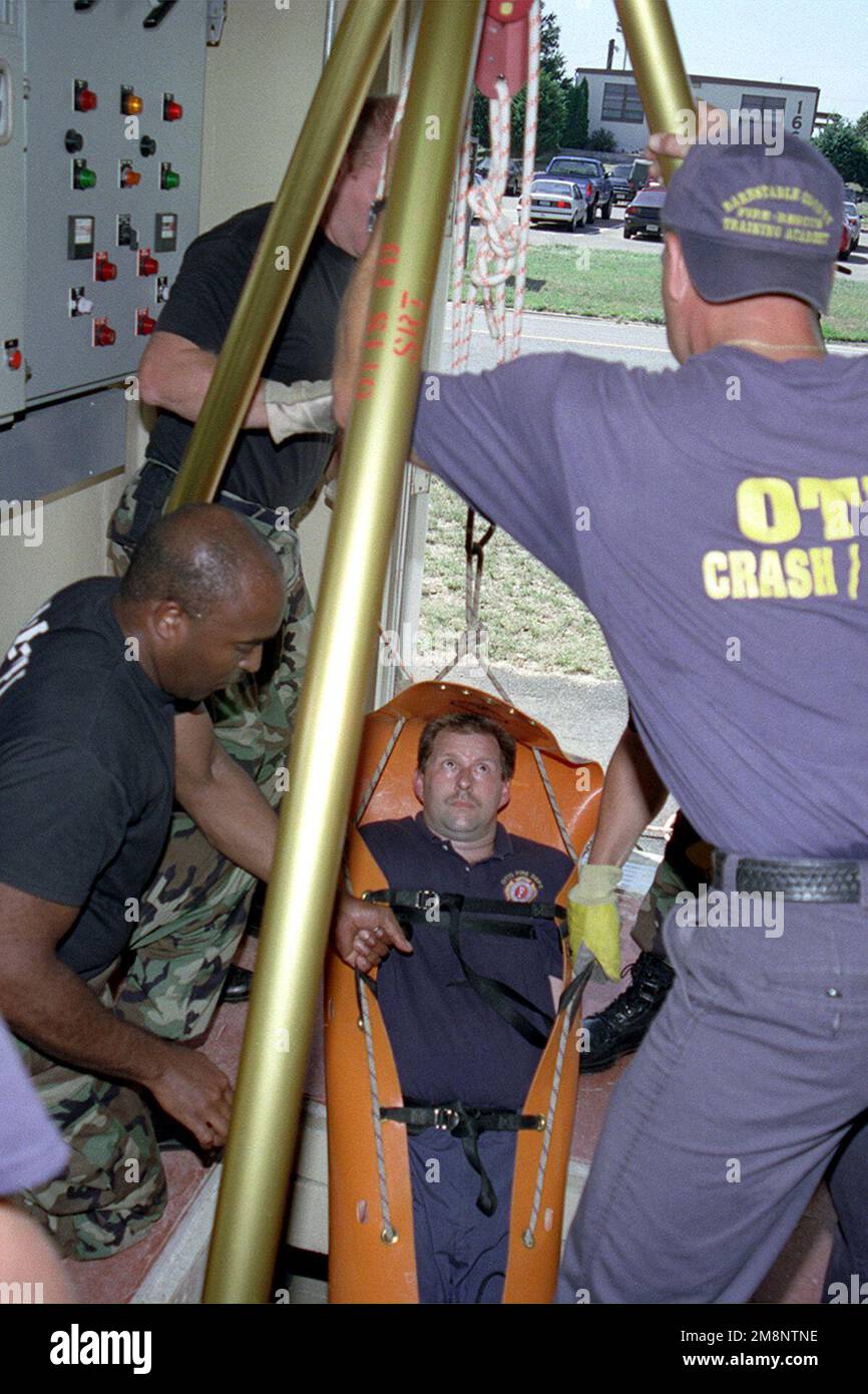 During a training exercise, a patient in a wrap-around stretcher is ...
