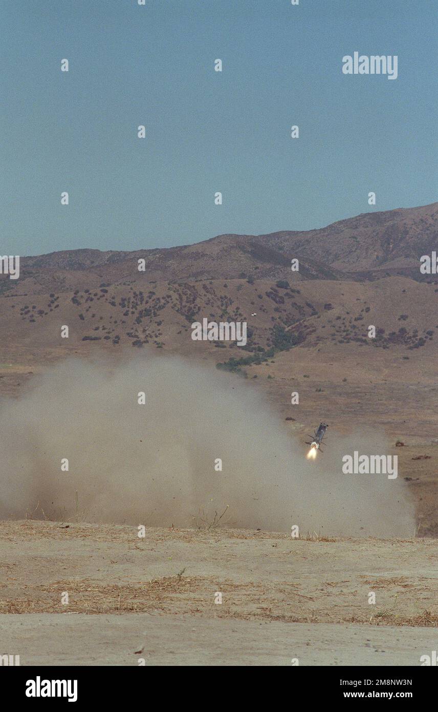 Long shot, rear view as a cloud of dust is kicked up by a Javelin ...