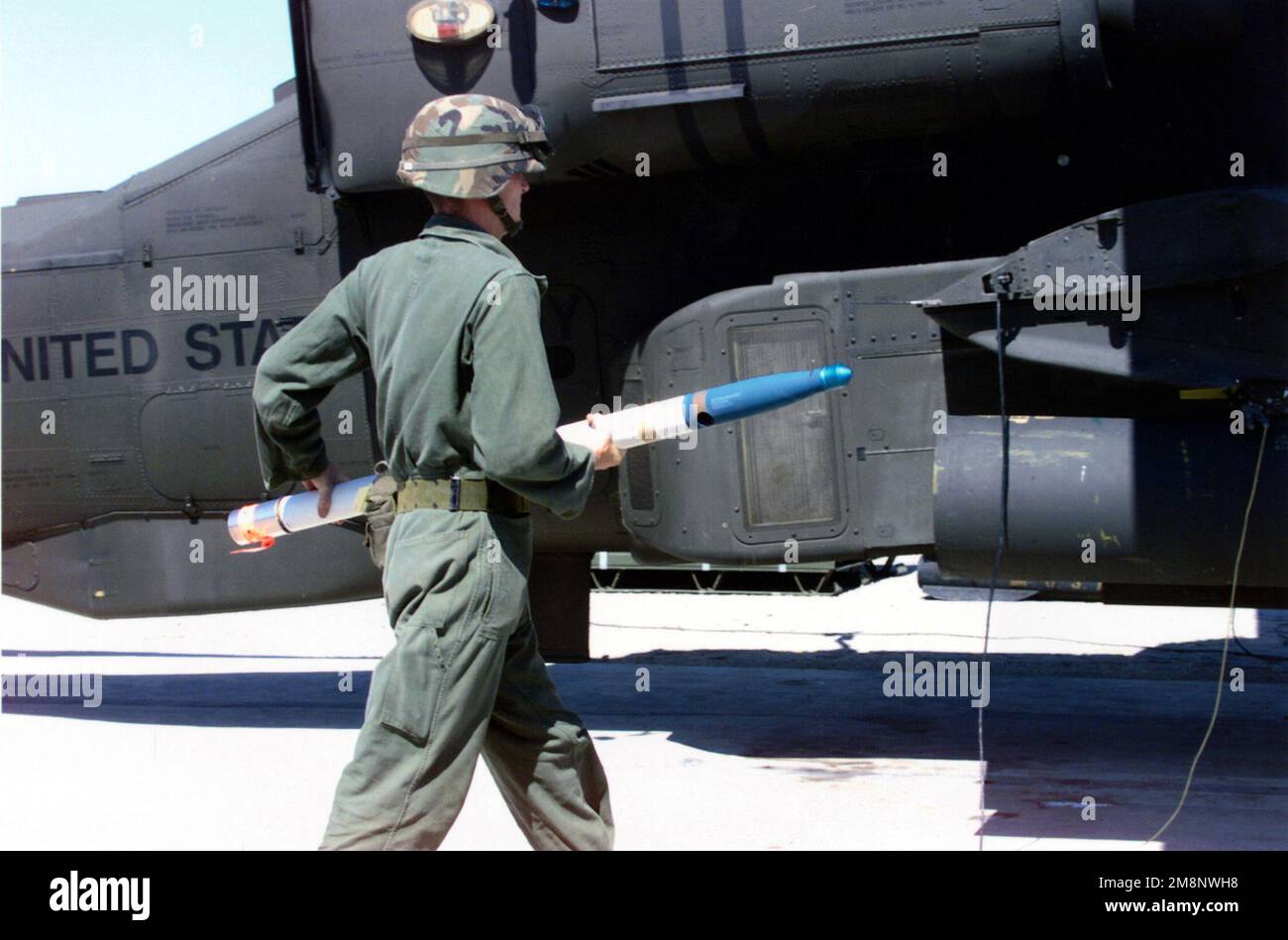 Sergeant John P. Green loads a 2.75 in FFAR (folding fin aerial rockets ...