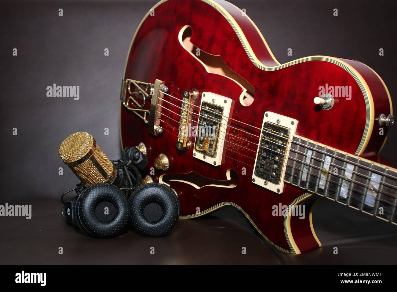 A semi acoustic electric guitar in red color Stock Photo - Alamy