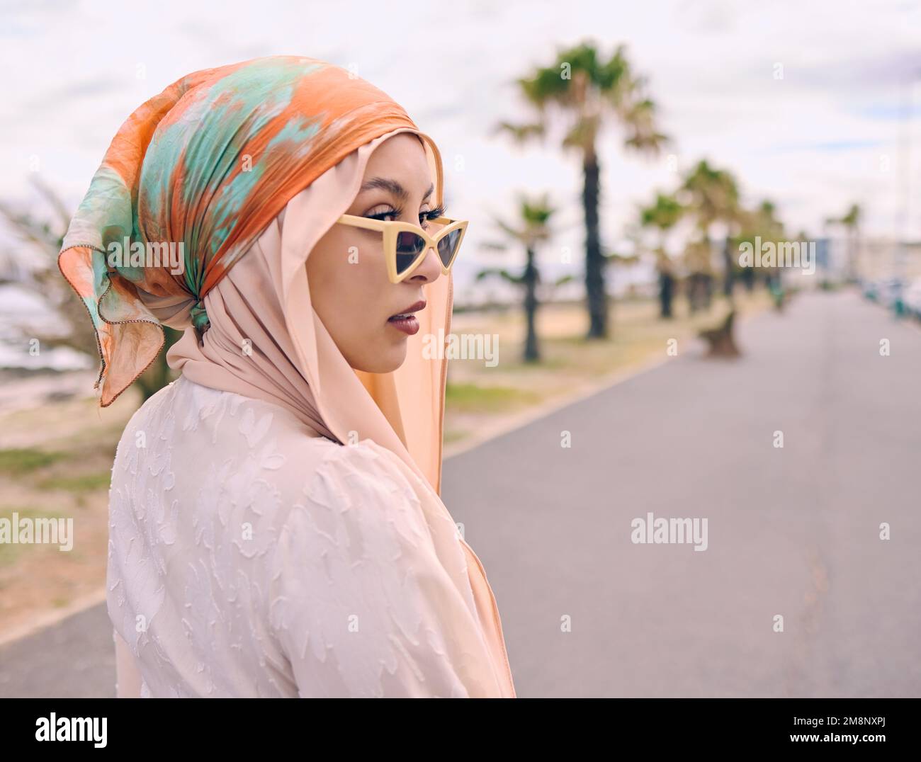 Beautiful young arab woman posing outdoors in a headscarf. Attractive ...