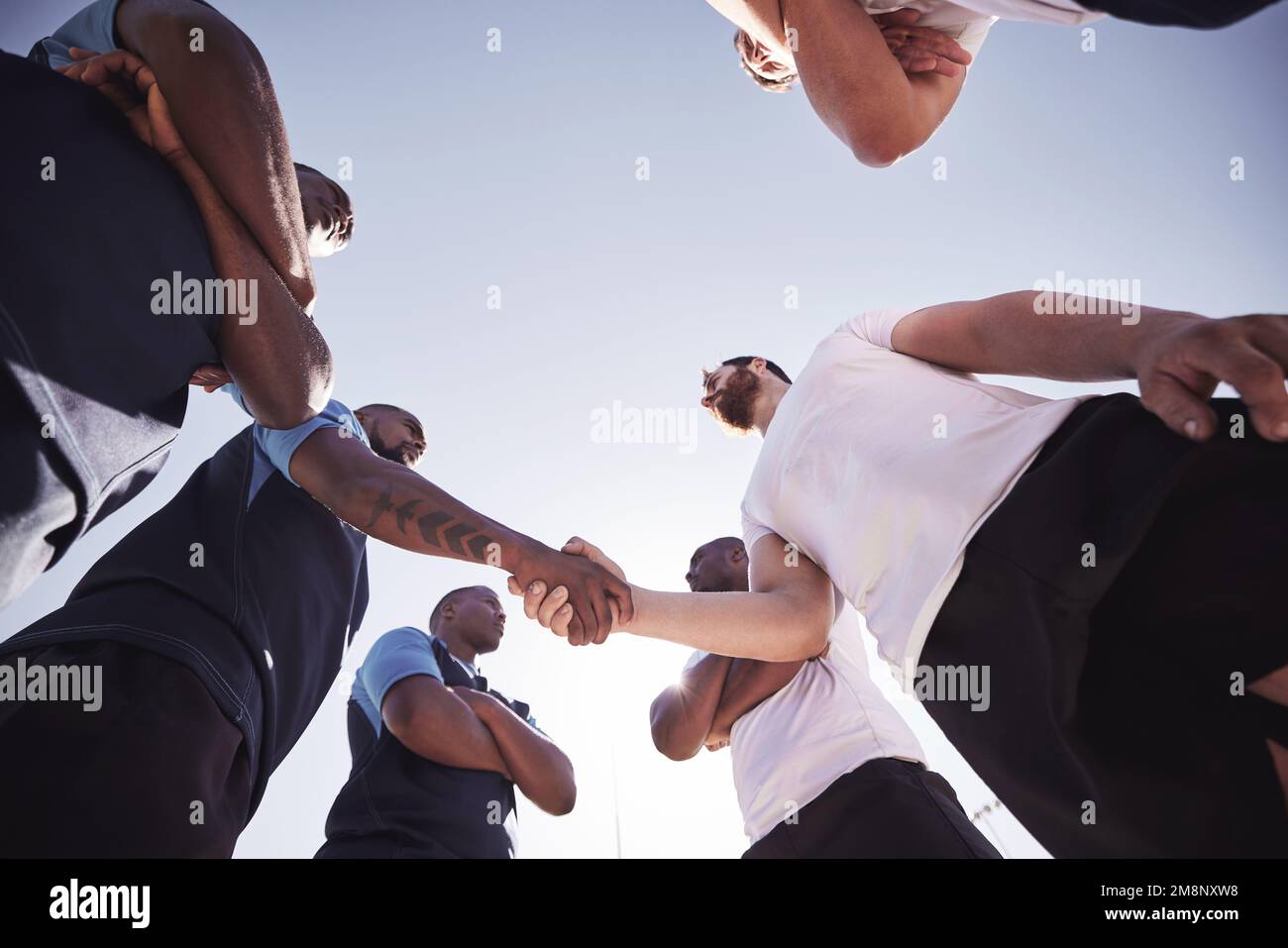 Below two opponent rugby teams shaking hands before or after a match ...