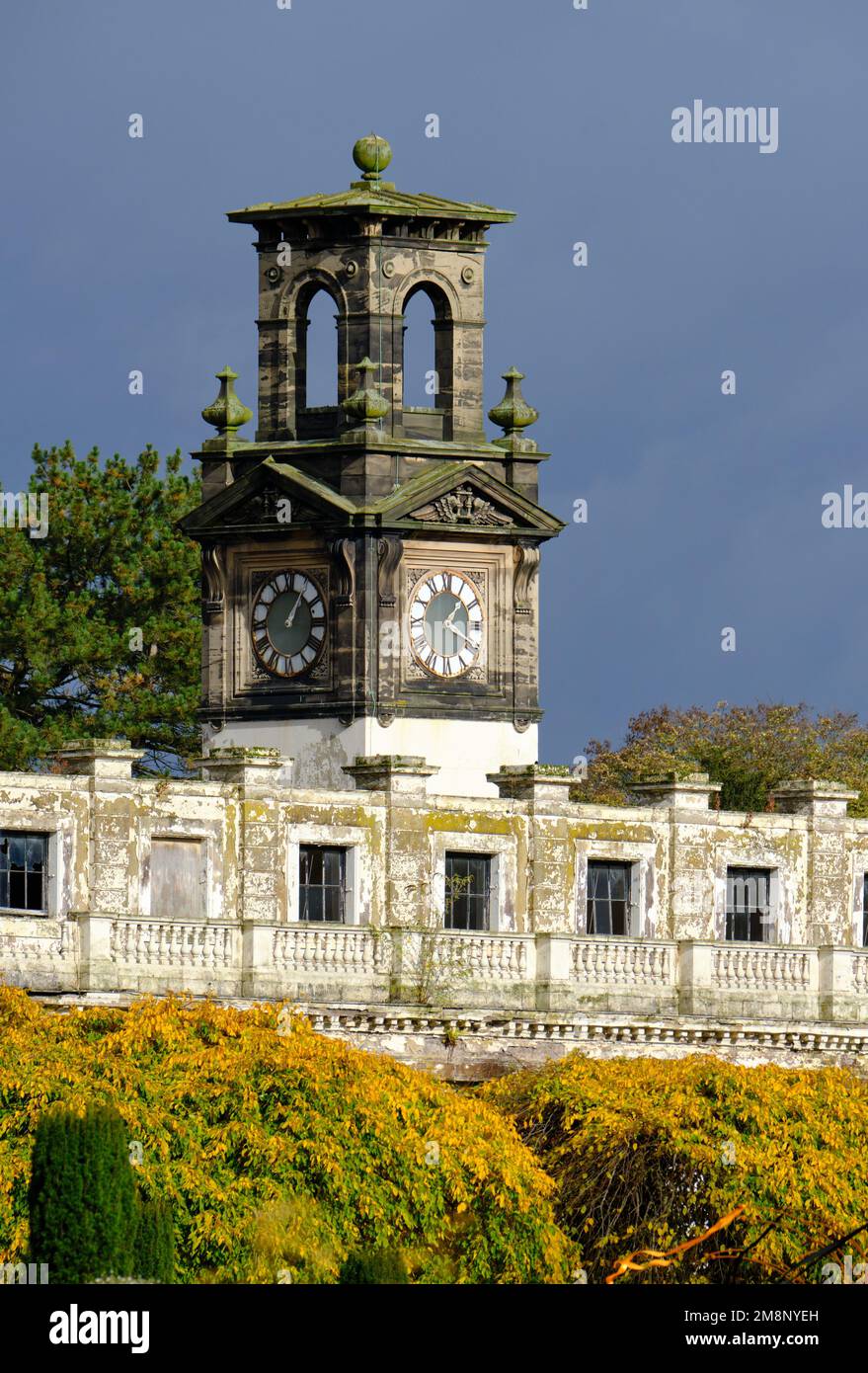 A vertical shot of a clock tower in Trentham Hall ruins at Trentham ...