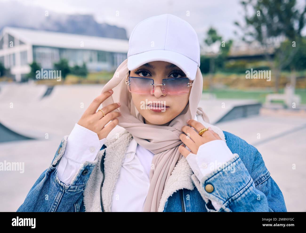 Beautiful young arab woman posing outdoors in a headscarf. Attractive ...