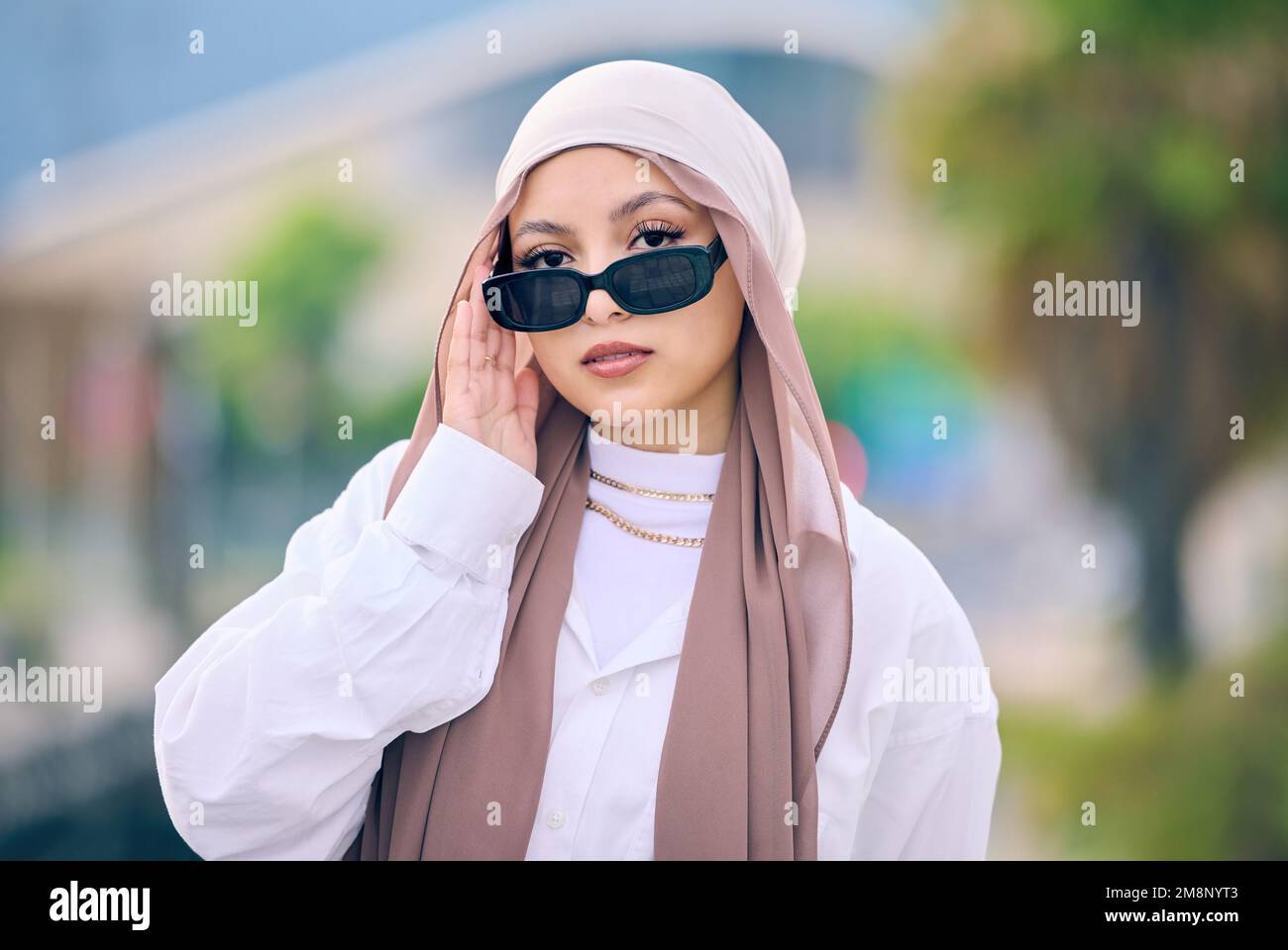 Beautiful young arab woman posing outdoors in a headscarf. Attractive ...
