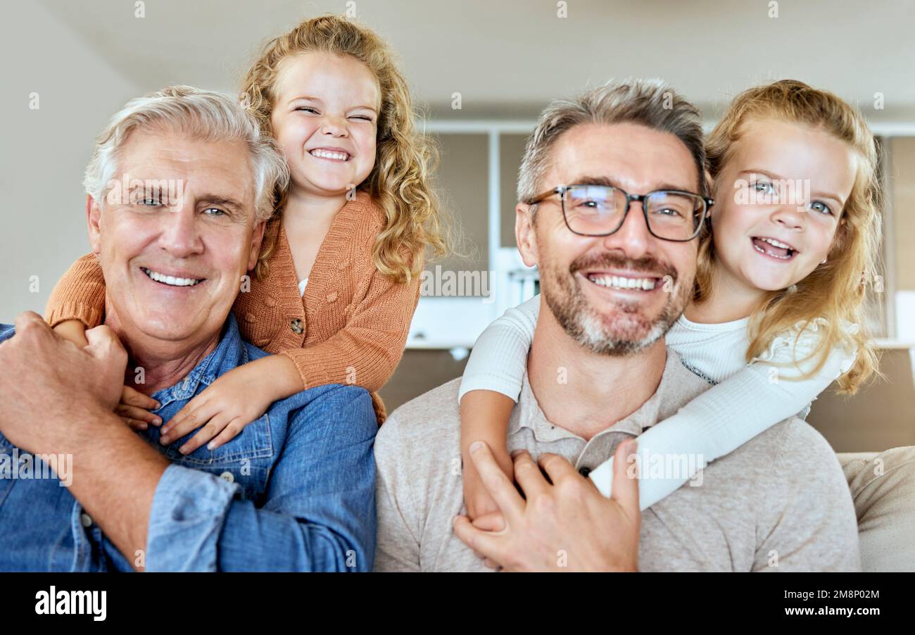 A happy multi generation family of four relaxing in the lounge and ...