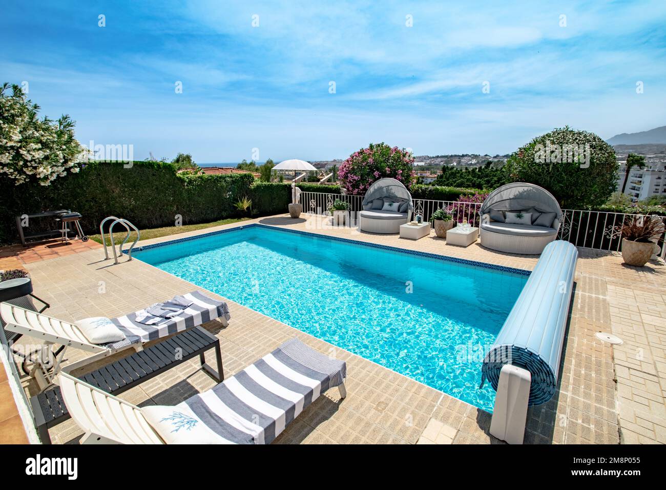 a poolside image inside a luxury chalet with Mediterranean views Stock ...