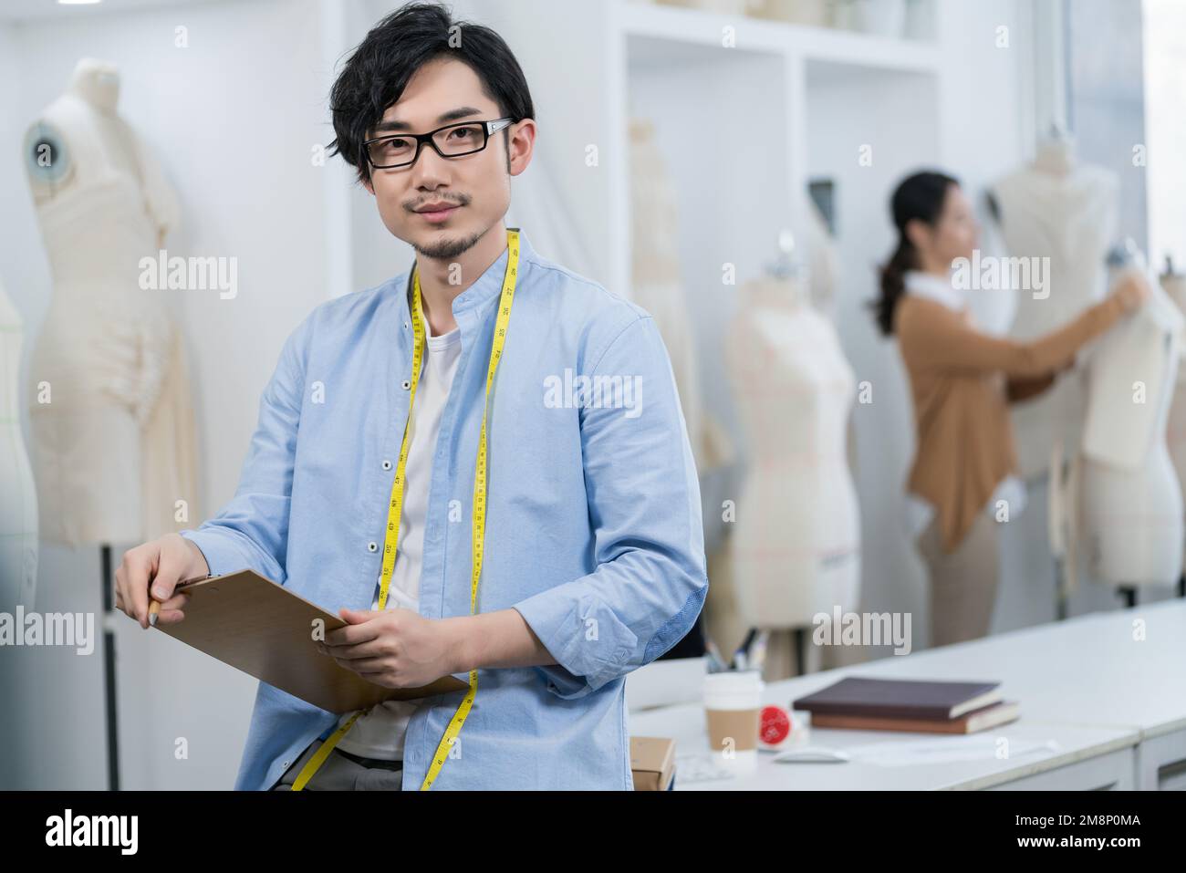 Two positive designers holding hi-res stock photography and images - Alamy