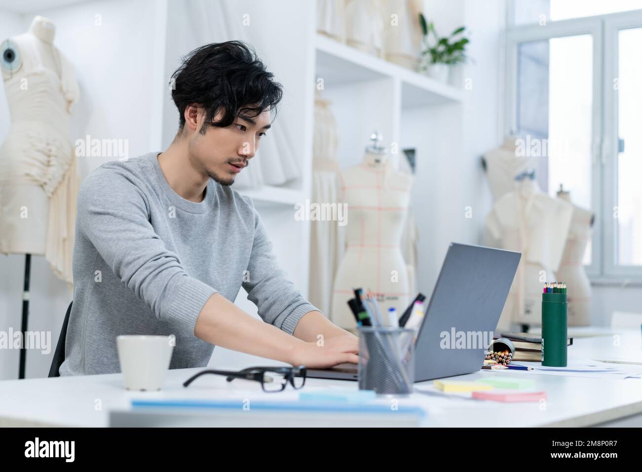 Serious young male designer thinking hi-res stock photography and ...