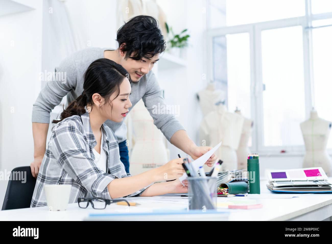 Two positive designers holding hi-res stock photography and images - Alamy