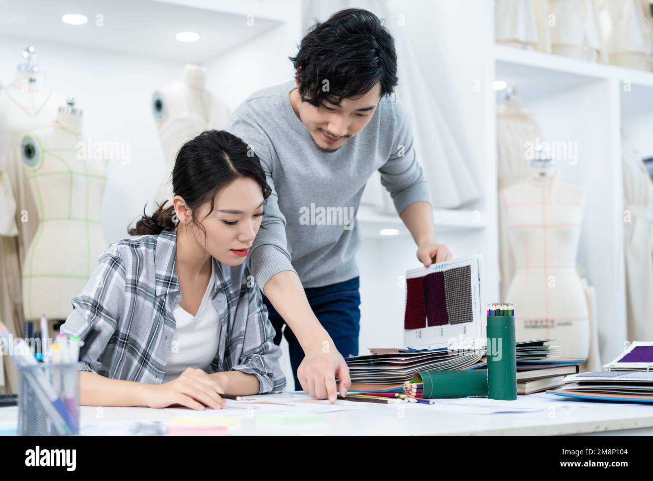 Two positive designers holding hi-res stock photography and images - Alamy