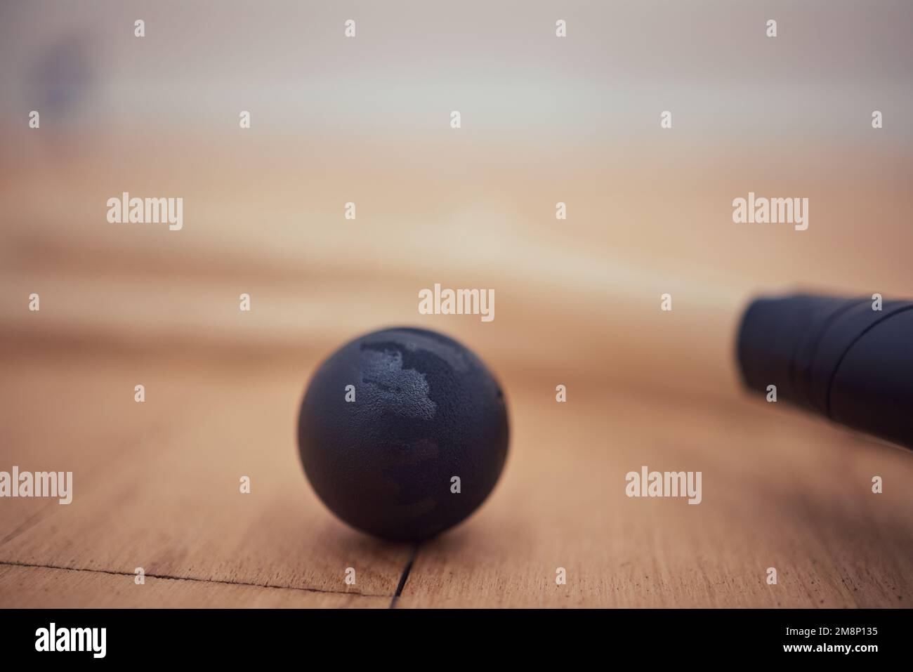 Closeup of squash equipment and gear on wooden floor in empty court in ...