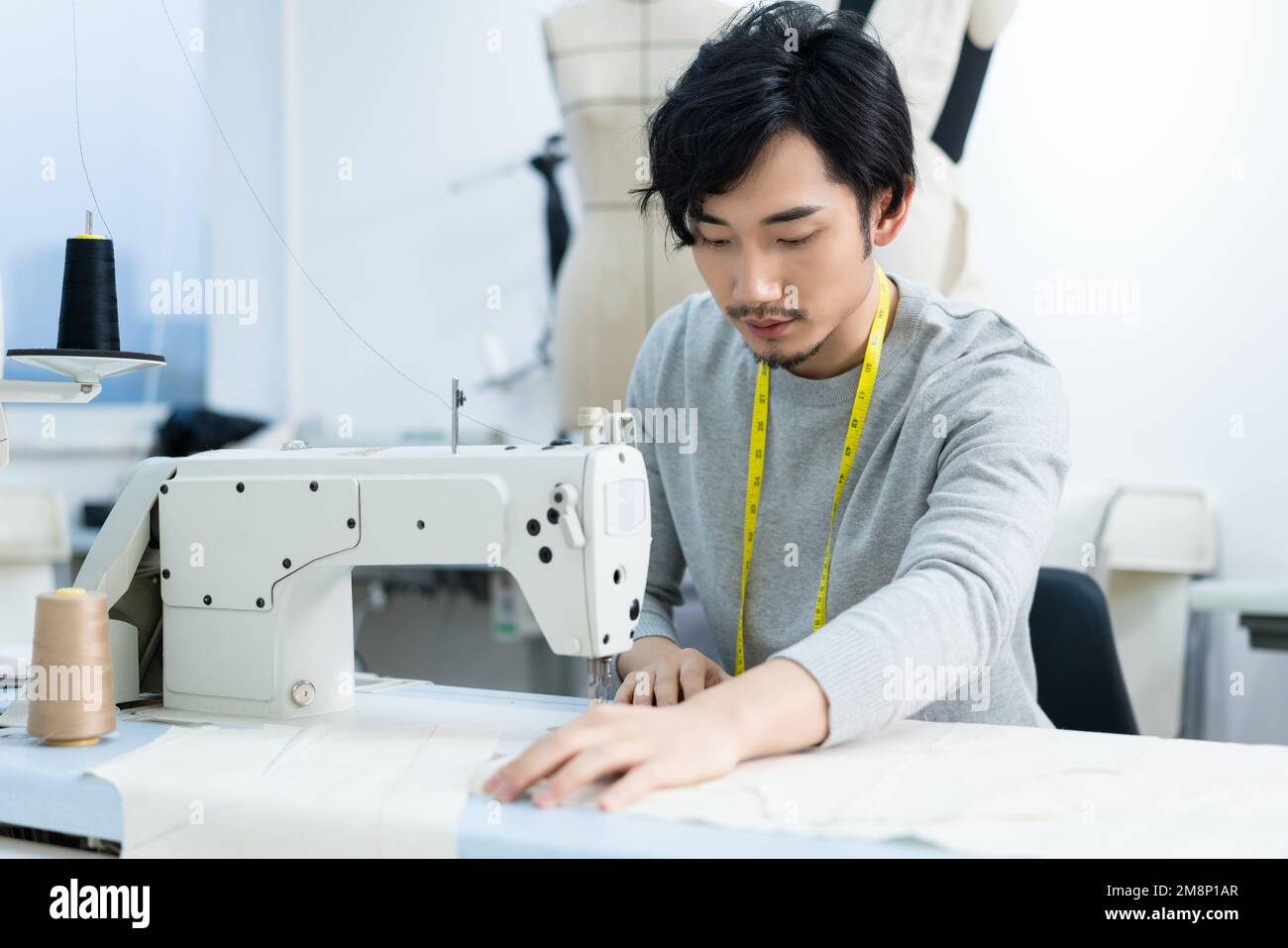 Asian male designer sewing machine hi-res stock photography and images ...